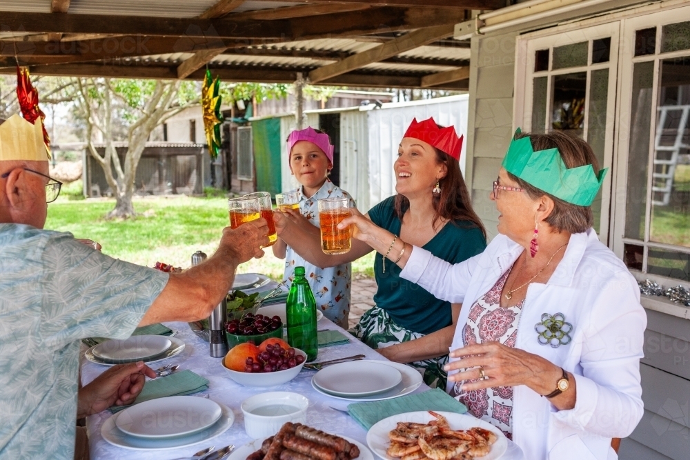 Image of Australian family together at Christmas lunch toasting with ...
