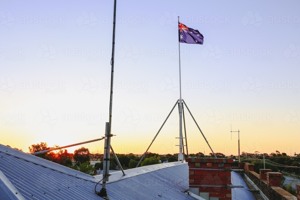 Image of Australian flag flying on roof of pub in small country town ...