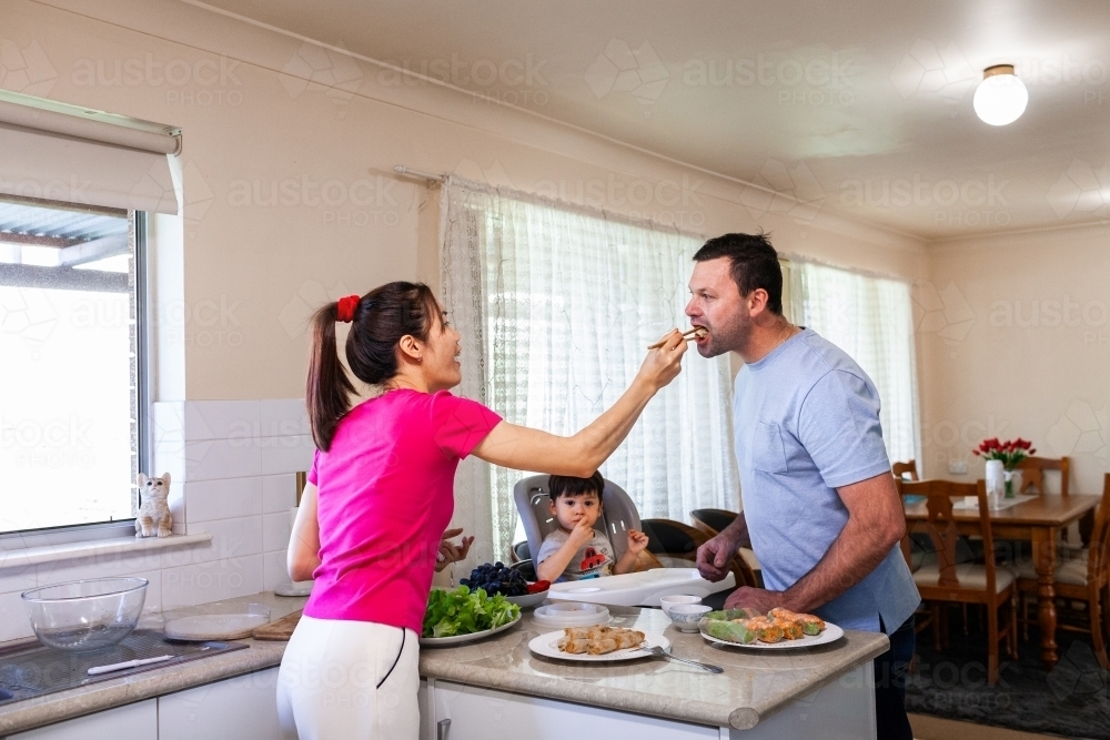 Image of Australian mixed race family eating afternoon tea together in ...