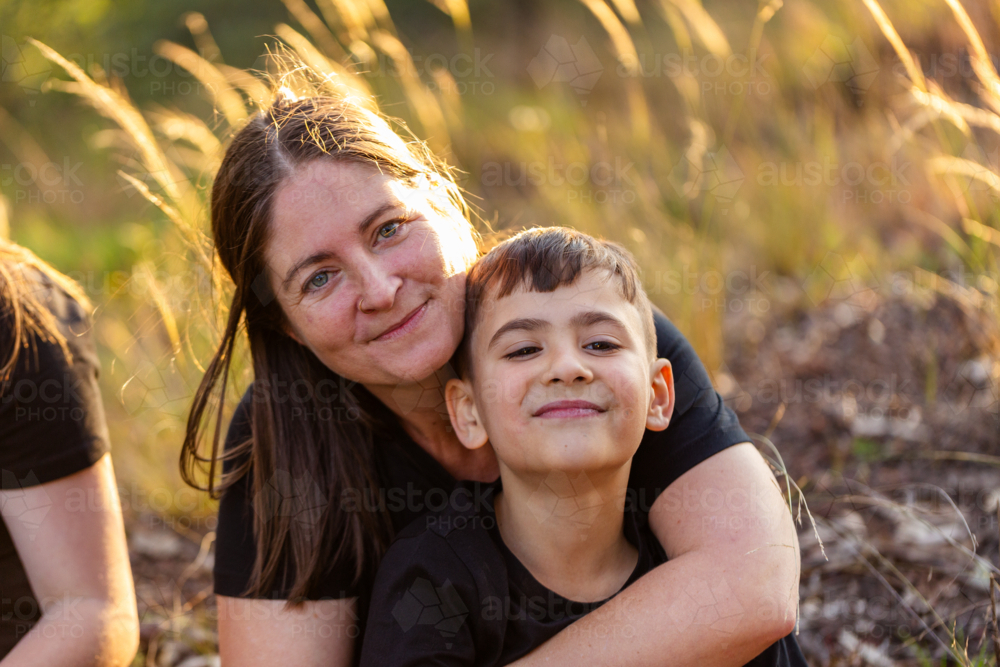 Image of Australian mum with her Aboriginal son sitting together ...