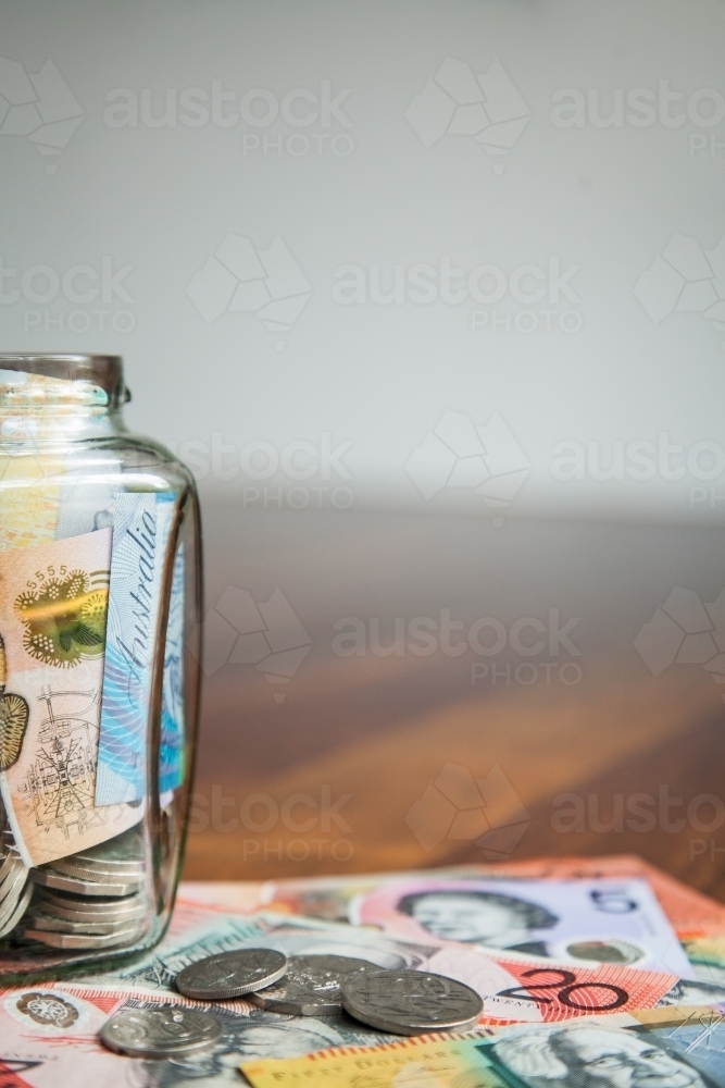 Image of Australian notes and coins in a jar with copy space - Austockphoto