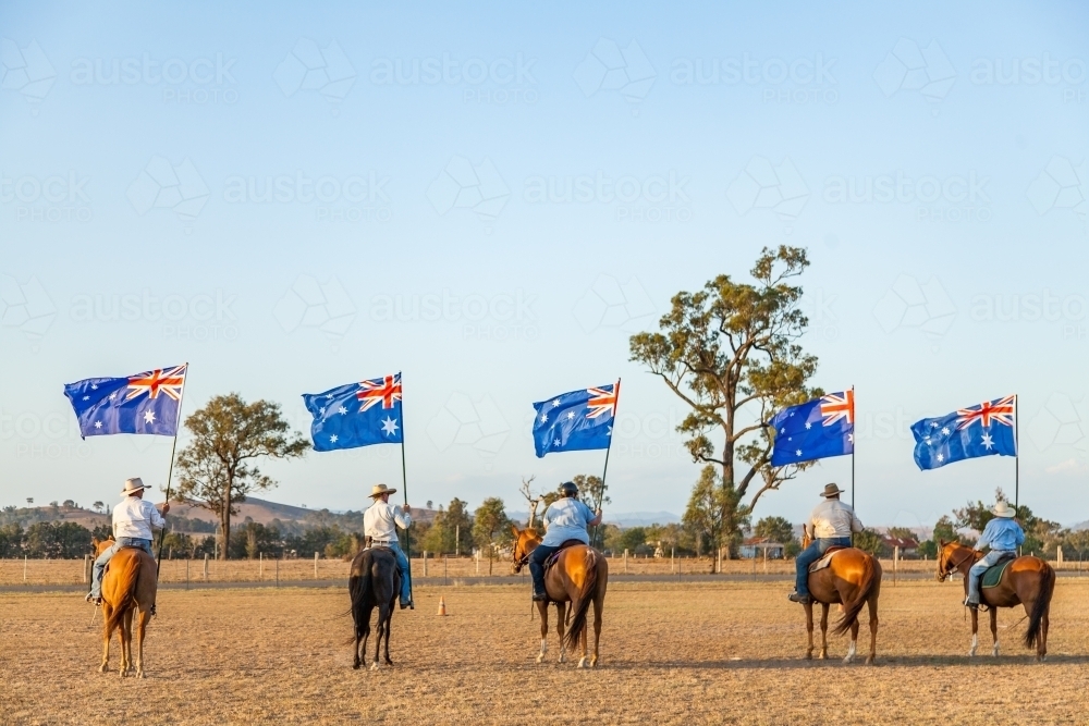 Image of Australian stock horse riders holding flags while Advance ...