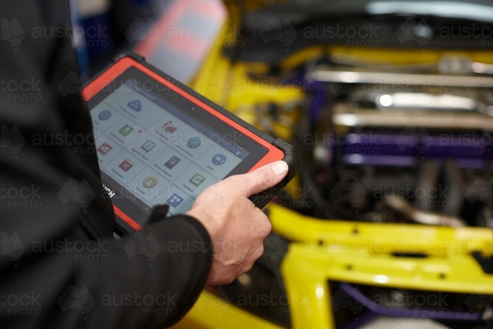 Image of Automotive work on engine of vehicle - Austockphoto