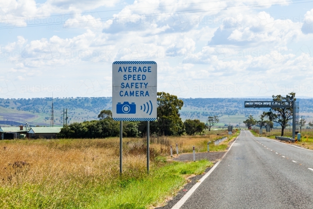 Image of Average speed safety camera ahead sign beside country highway ...