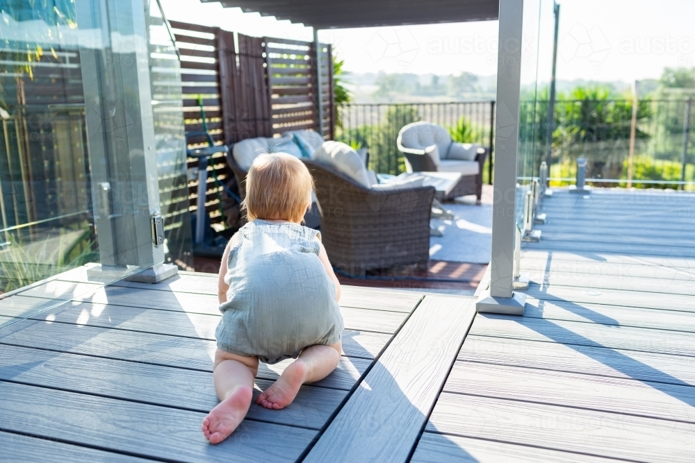 Image of Baby crawling towards unsafe open pool gate in aussie backyard ...