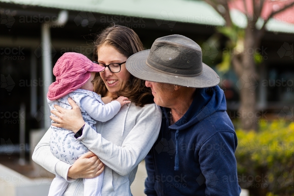 Image of Baby cuddling with extended family - aunty and grandfather ...