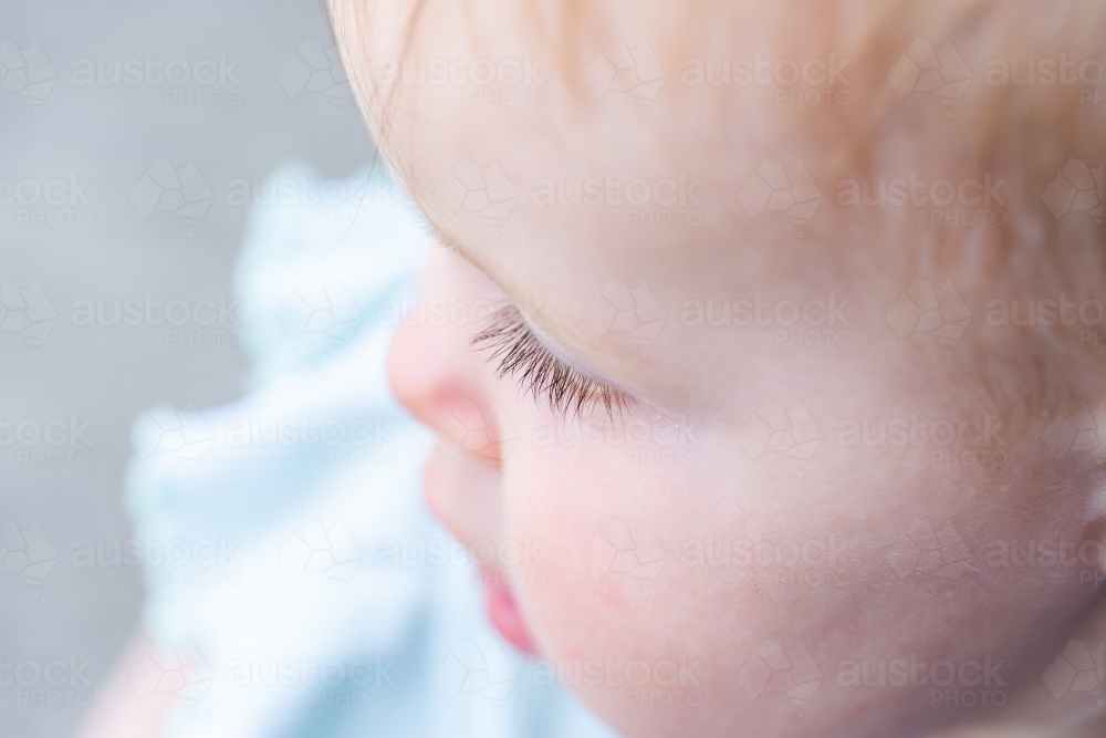 Image of Baby looking down with focus on eyelash - Austockphoto
