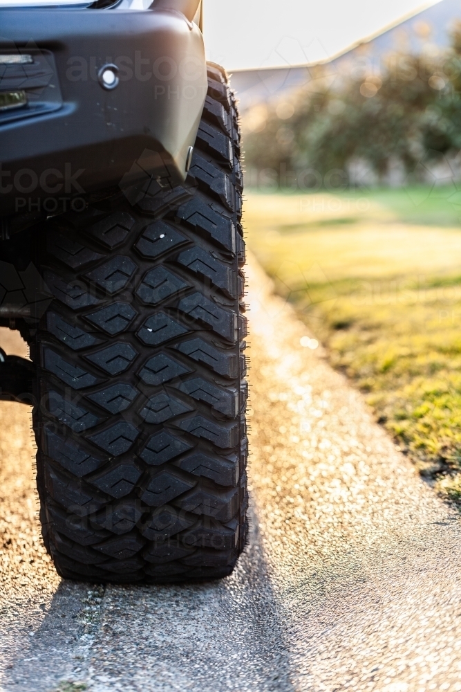 Image of Backlit four wheel drive car tyre on the road - Austockphoto