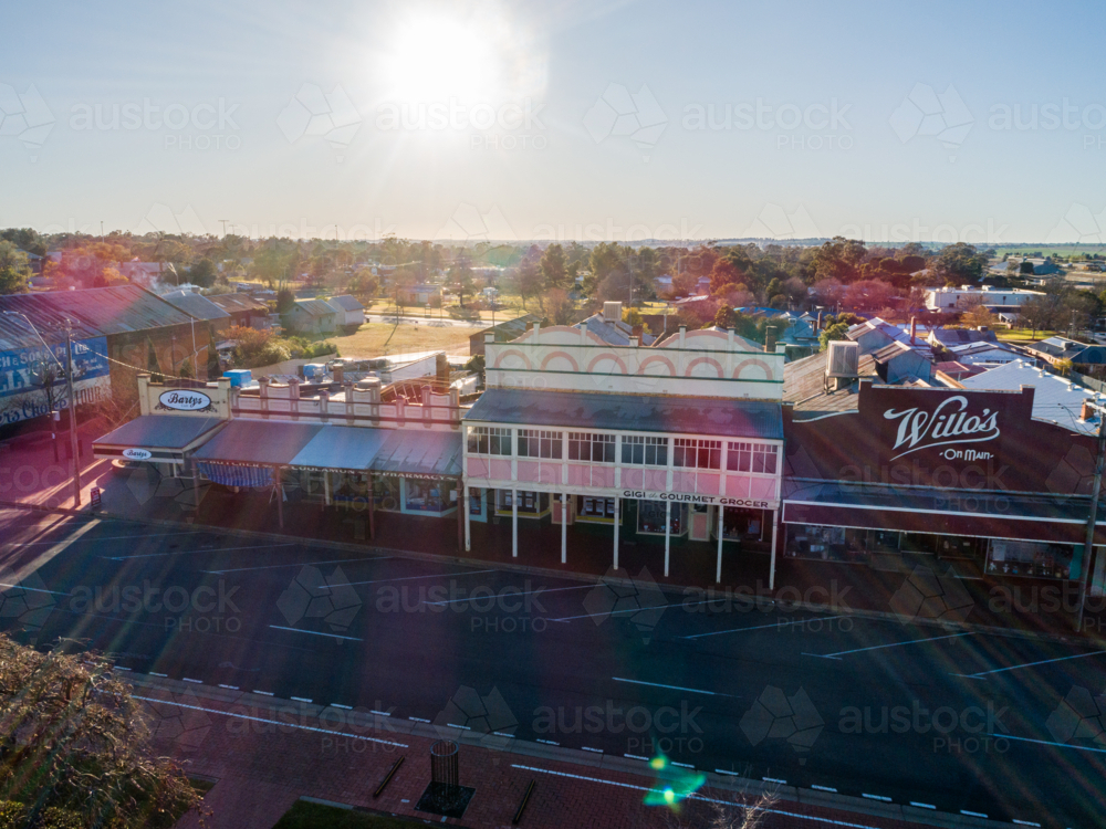 Image of backlit shopfronts along main street in country town of ...