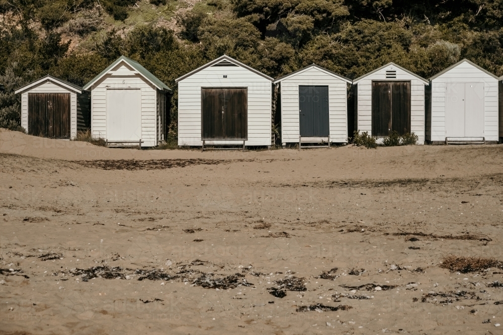 Image of Bathing boxes on a sandy beach - Austockphoto