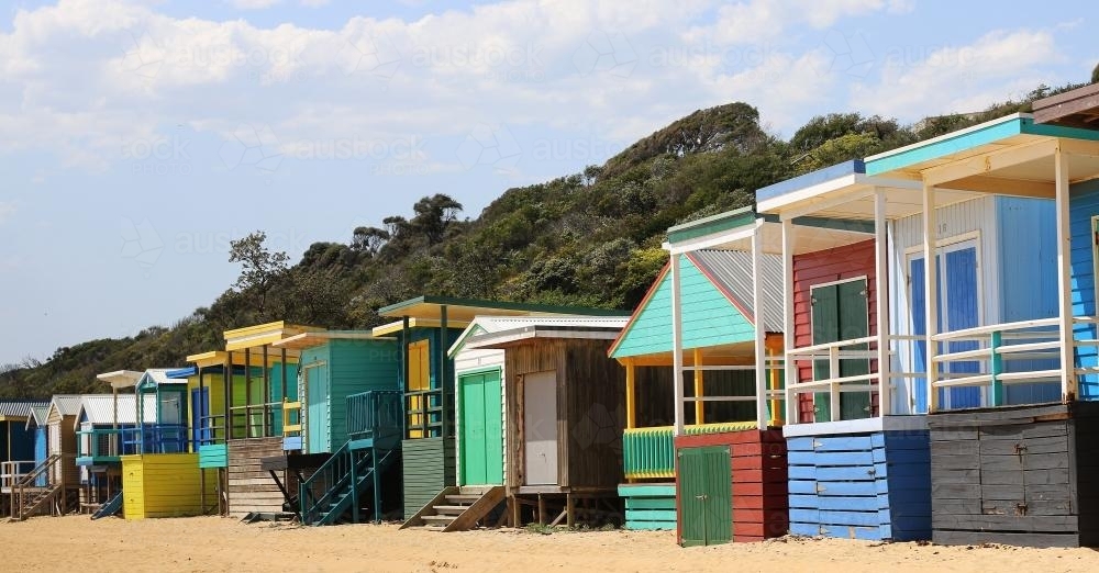 Row of bright beach boxes on a sunny summers day