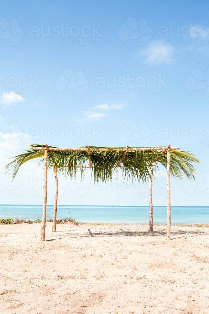 Image of Beach shed with a thatched palm leaf as a roof. - Austockphoto