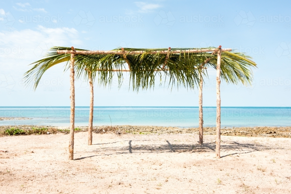 Image of Beach shed with a thatched palm leaf as a roof. - Austockphoto