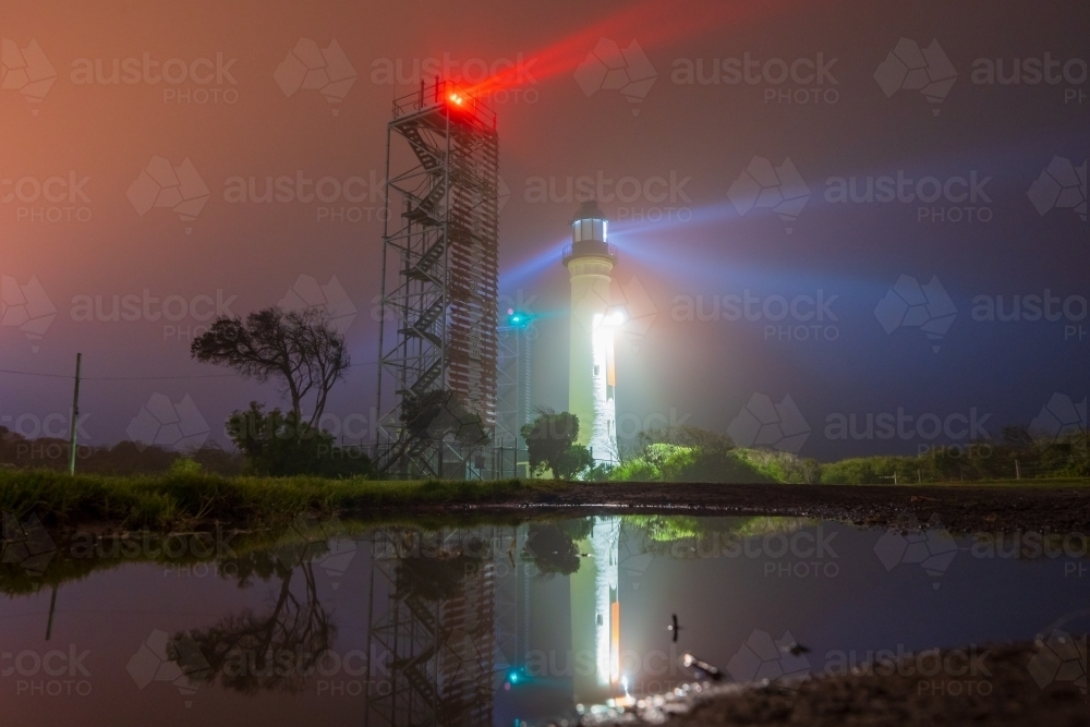 Image of Beams of light from a lighthouse and beacon tower reflected in ...