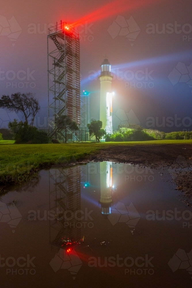 Image of Beams of light from a lighthouse and beacon tower reflected in ...