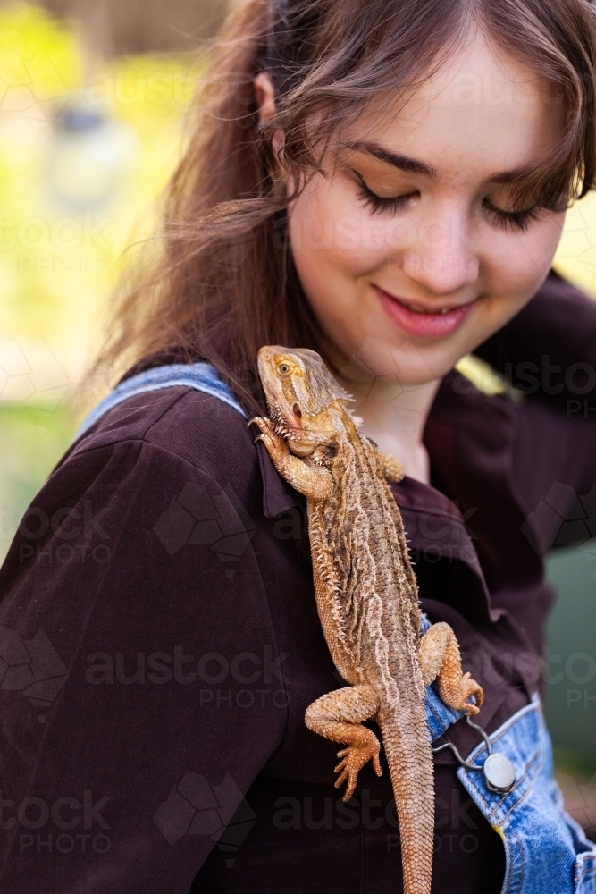 Image of Bearded dragon lizard sitting on young lady - Austockphoto