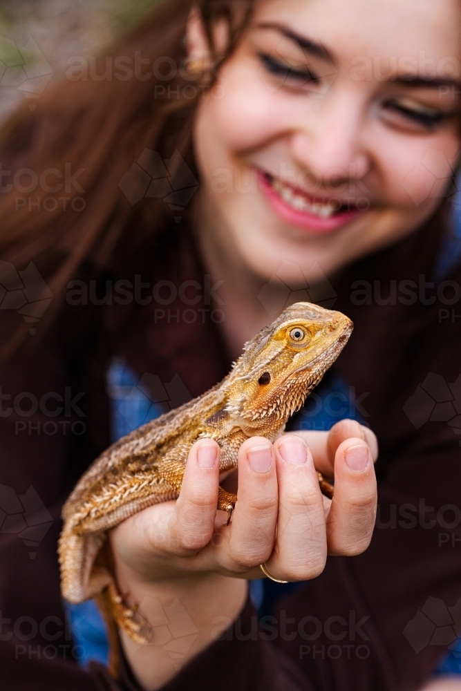 Image of Bearded dragon lizard sitting on young lady - Austockphoto