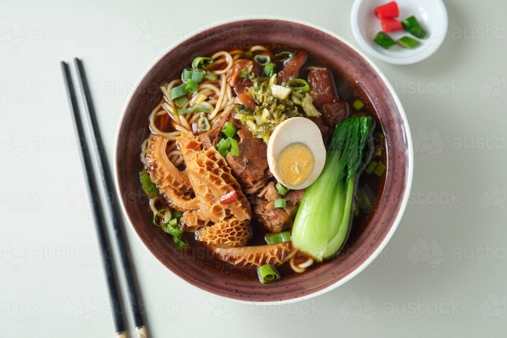 Image of Beef gravy and tripe and tendon noodle soup - Austockphoto