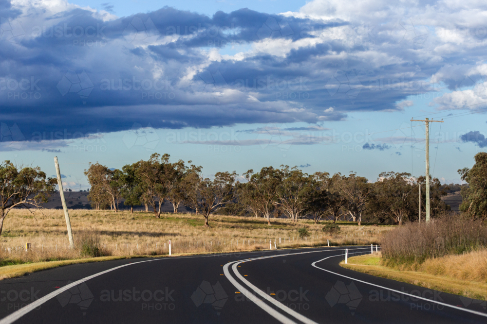 Image of Bend in sealed road with double lines down rural highway in ...