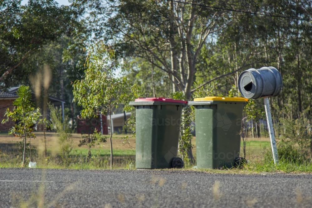 Image of Bins waiting for collection beside a a mailbox - Austockphoto