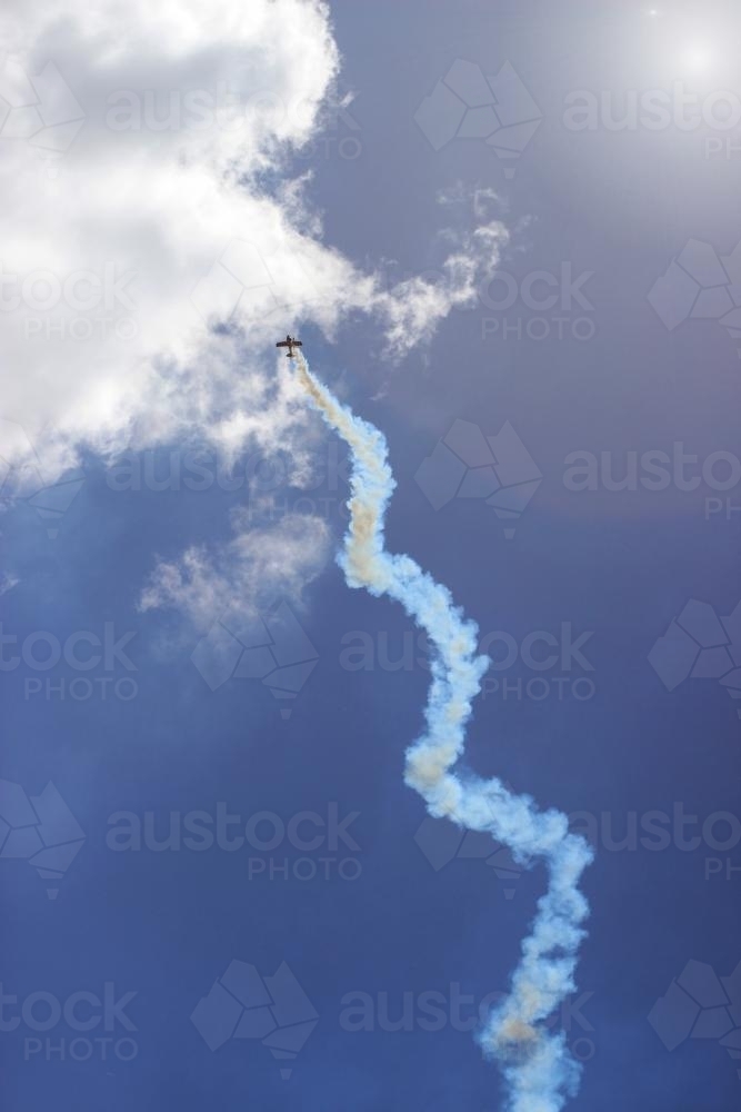 Image of Biplane doing aerobatics in the distance - Austockphoto