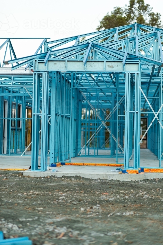 Image of Blue metal frame structure of house being built - Austockphoto