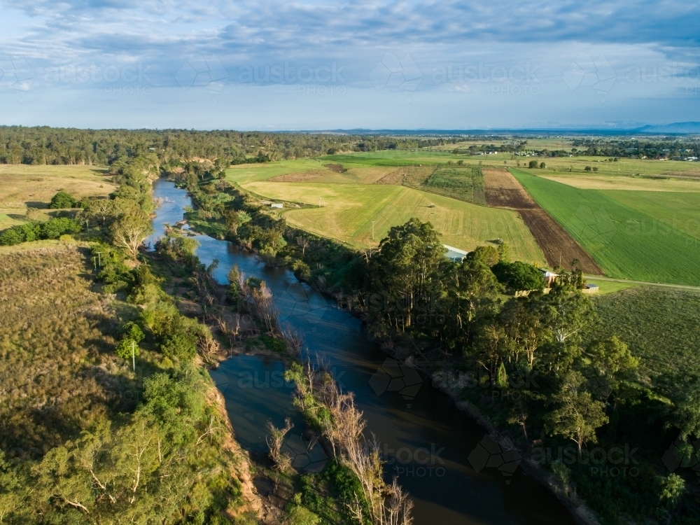 Image of Blue sky reflecting on Hunter River watercourse running beside ...