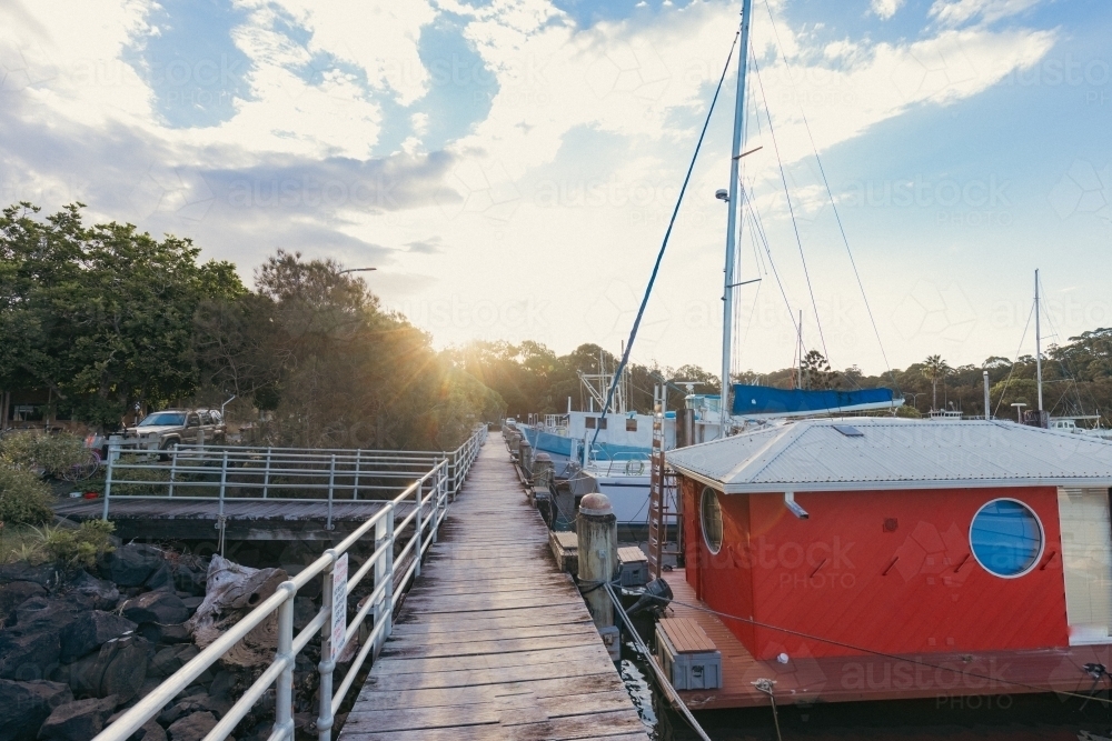 Image of Boats moored along jetty at Brunswick Heads Marina - Austockphoto