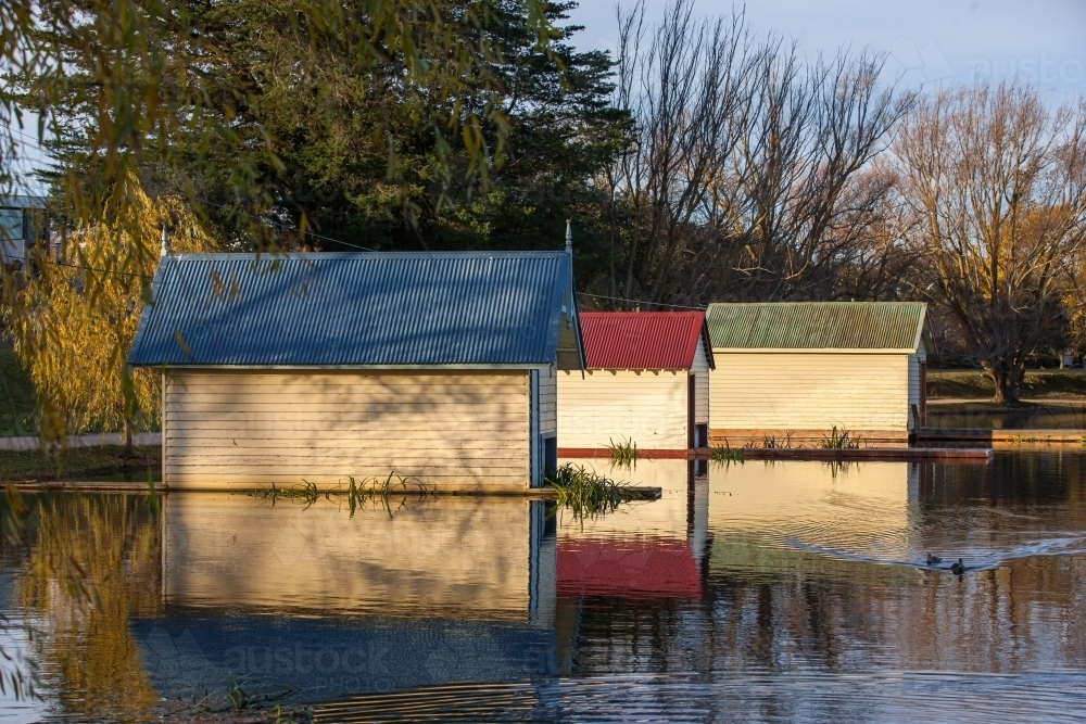 Image of Boatsheds on lake - Austockphoto