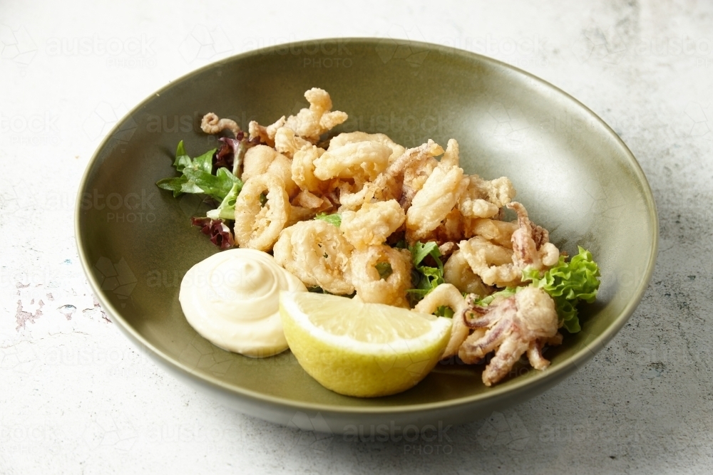 Image of Bowl of calamari with lemon and mayonnaise - Austockphoto