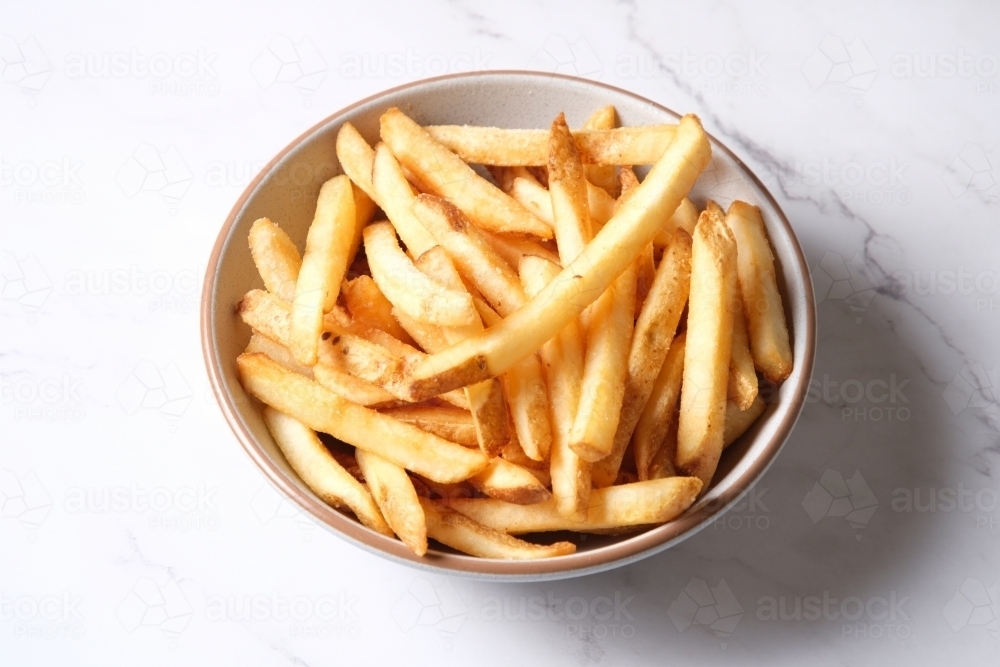 Image of Bowl of hot chips on marble table - Austockphoto