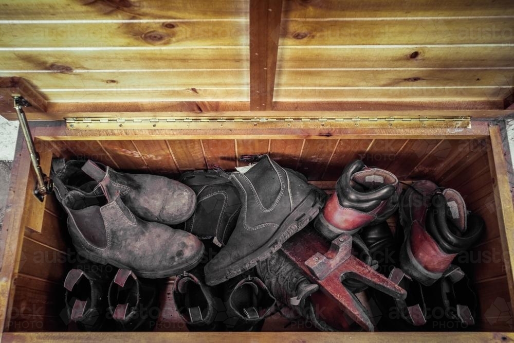 Image of Box of dirty farm boots - Austockphoto