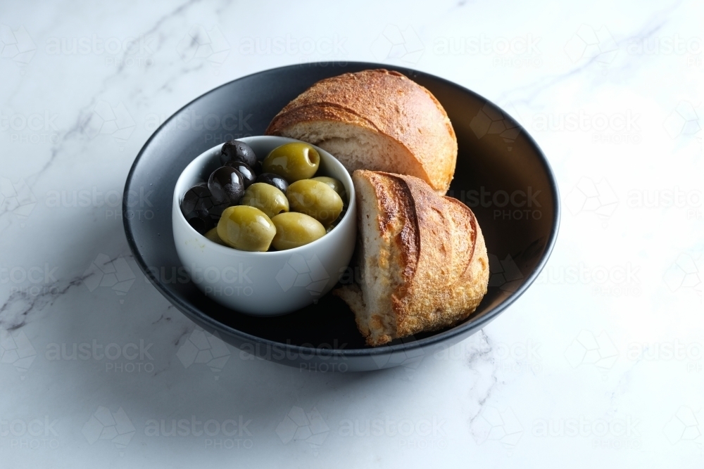 Image of Bread in a bowl with olive dish - Austockphoto
