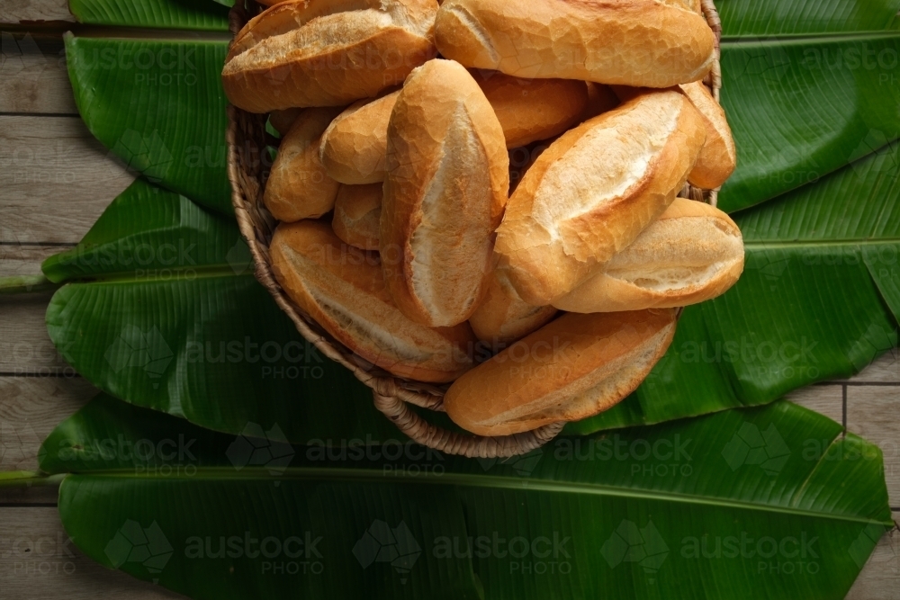 Image of Bread rolls in basket on palm leaf - Austockphoto