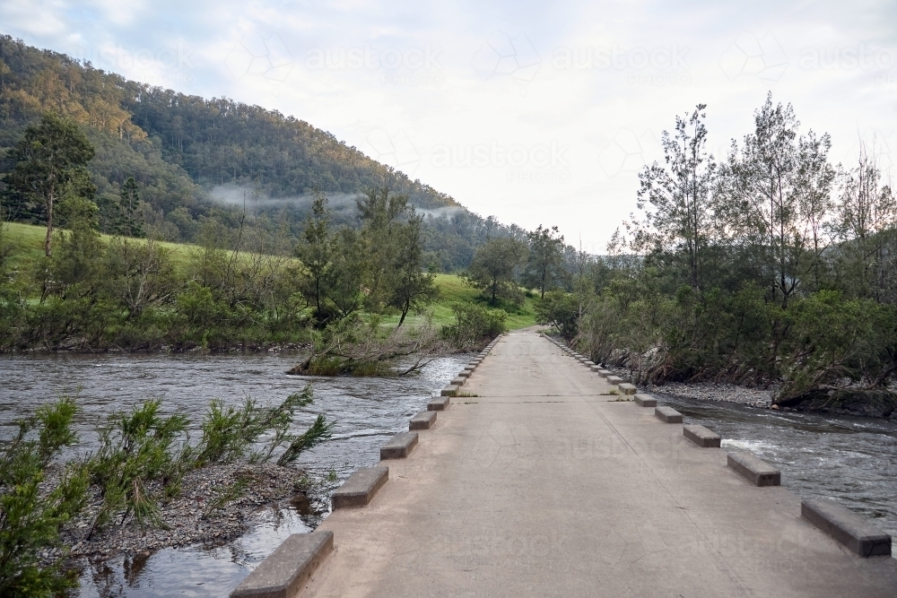 Image of Bridge crossing river in rural setting - Austockphoto