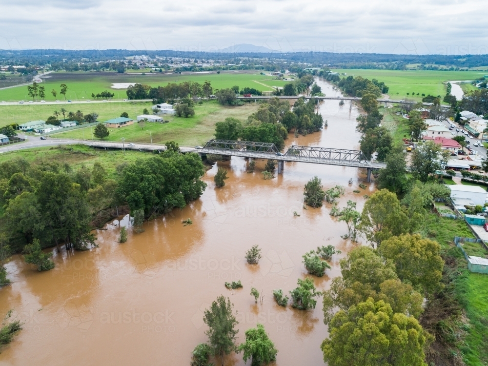 Image of Bridge over river with receding floodwaters in flood aftermath ...