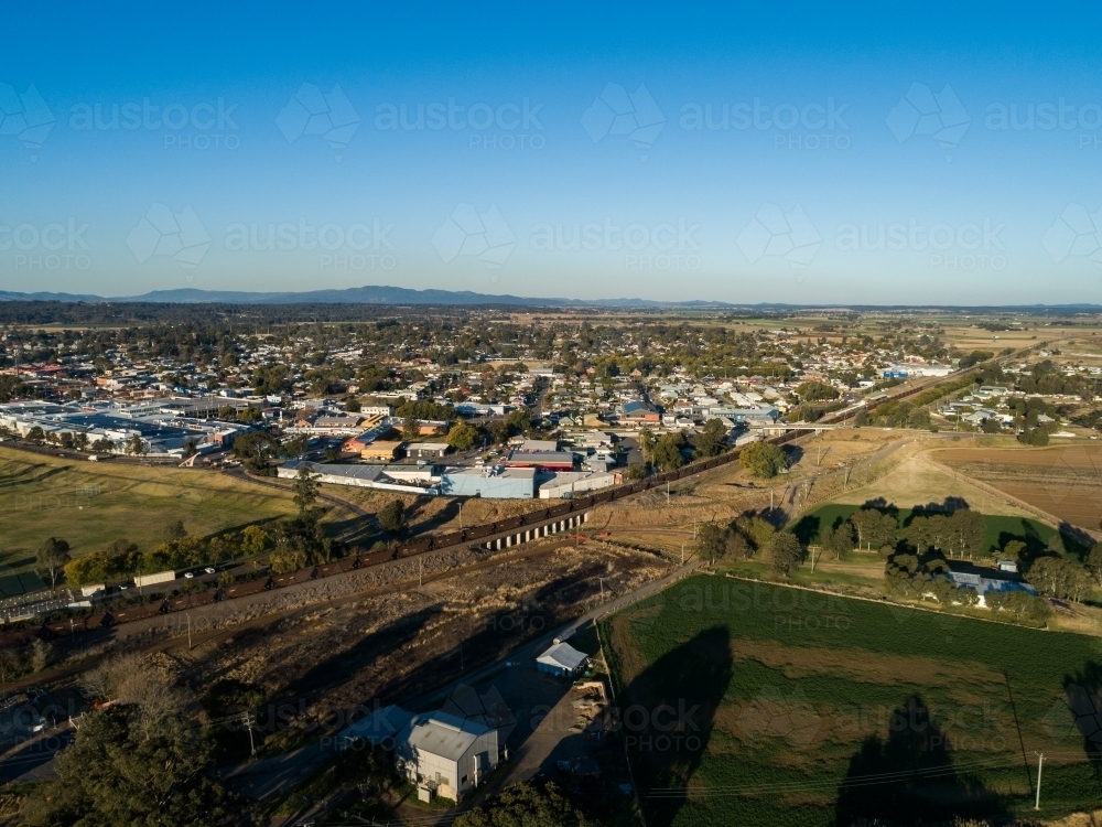 Image of bright afternoon light on edge of town with railway - Austockphoto