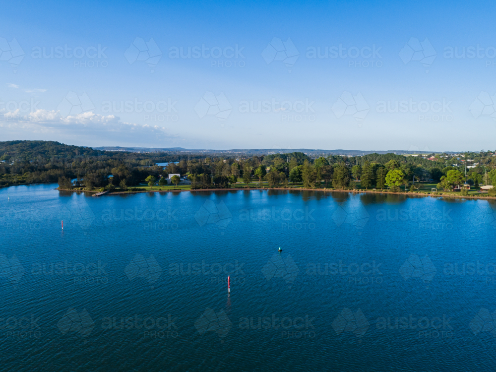 Image of bright blue waters of coastal lake seen from aerial view on ...