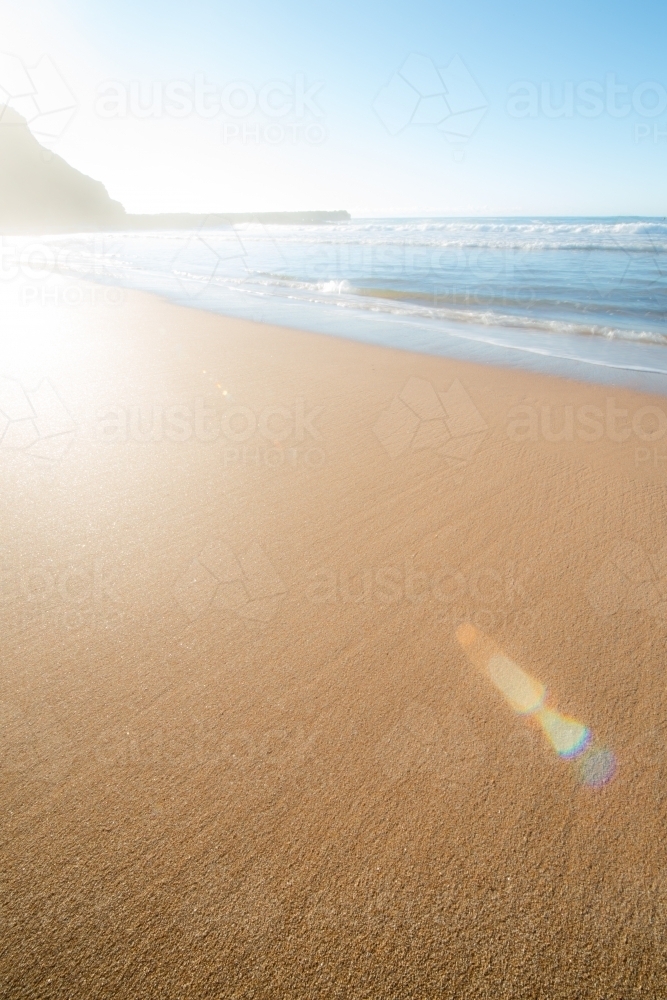 Image of Bright sun flare on untouched empty yellow sandy beach ...