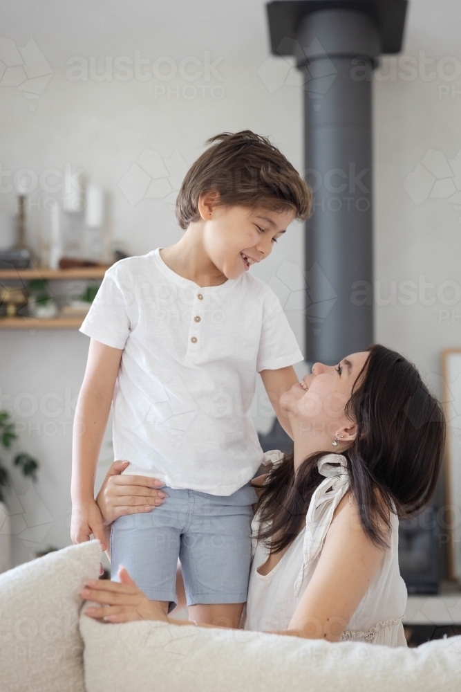 Image of Brother and sister on couch at home together - Austockphoto