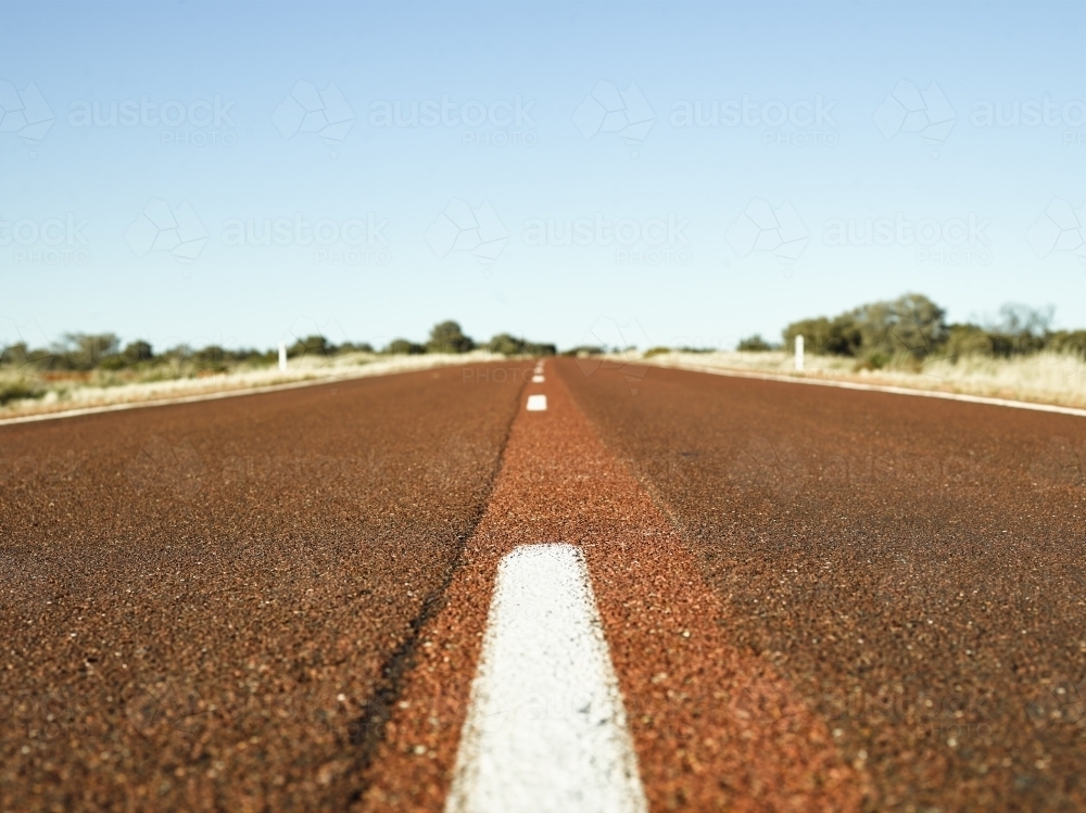 Image of brown bitumen highway in outback - Austockphoto