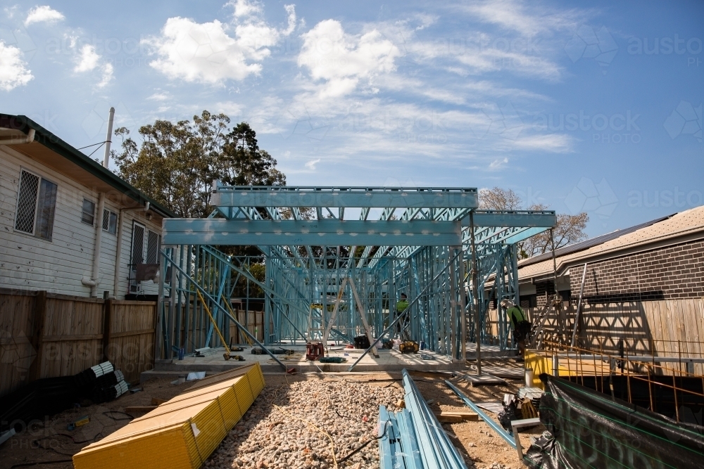 Image of building a house frame on a narrow suburban block - Austockphoto