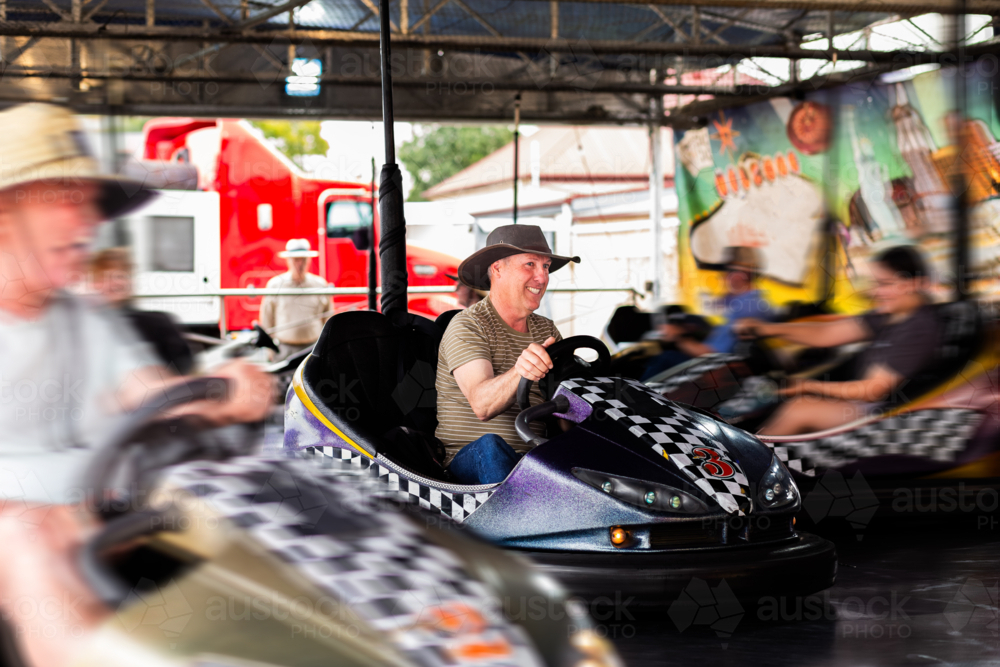 Image of Bumper cars ride with Aussie man riding dodgem car at carnival ...