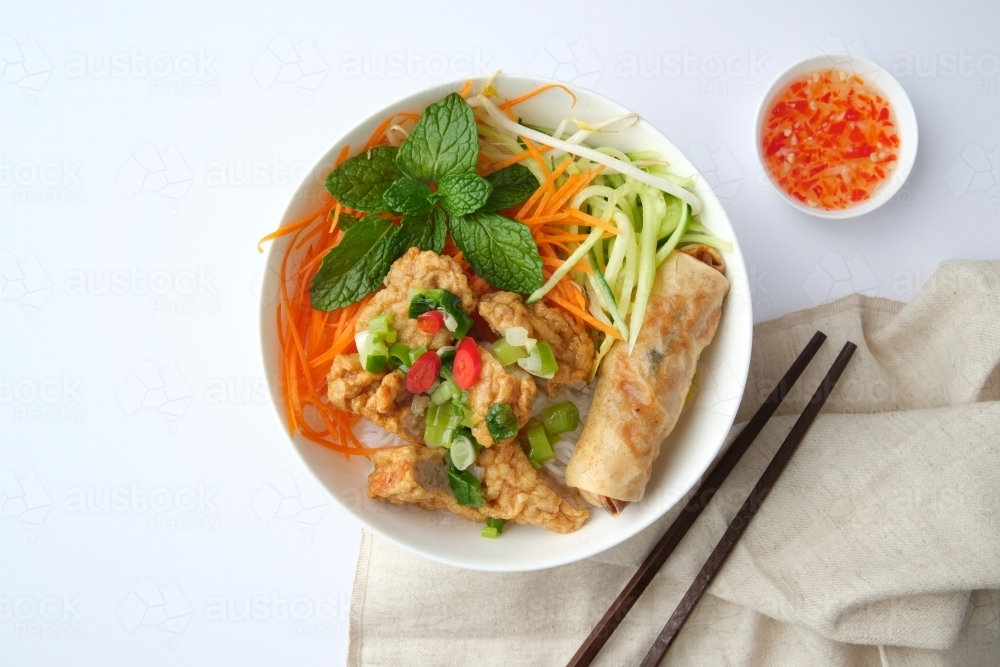Image of Bun Cha Gio bowl topped with fried spring roll and Cha Lua. - Austockphoto