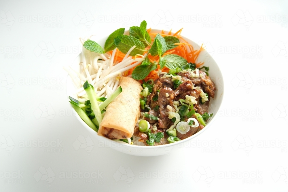 Image of Bun Cha Gio bowl with meat slices topped with fried spring ...