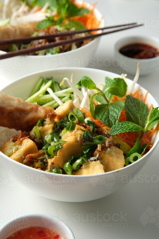 Image of Bun Cha Gio bowls on a white countertop with a small dish of ...
