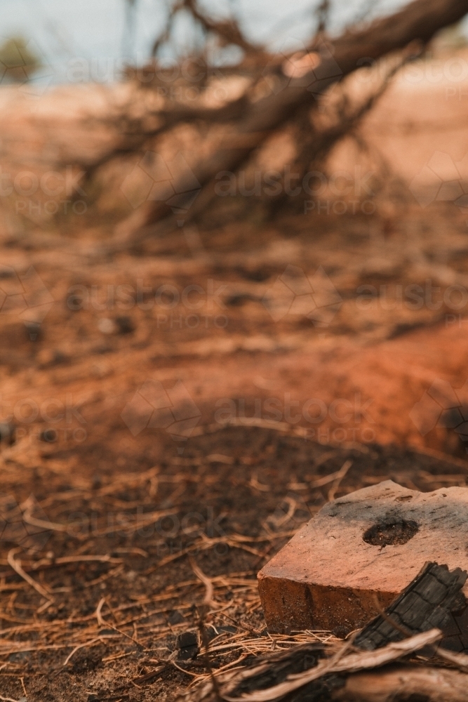 Image of Burned charred bricks on dry farm land - Austockphoto