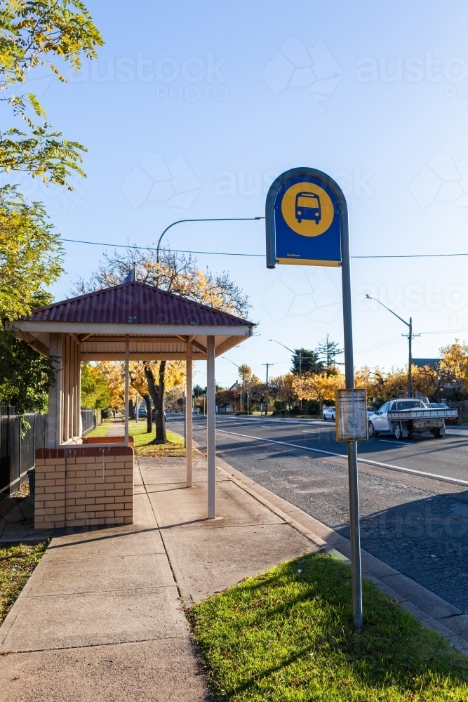 Image of Bus stop sign and shelter on street of rural country town ...