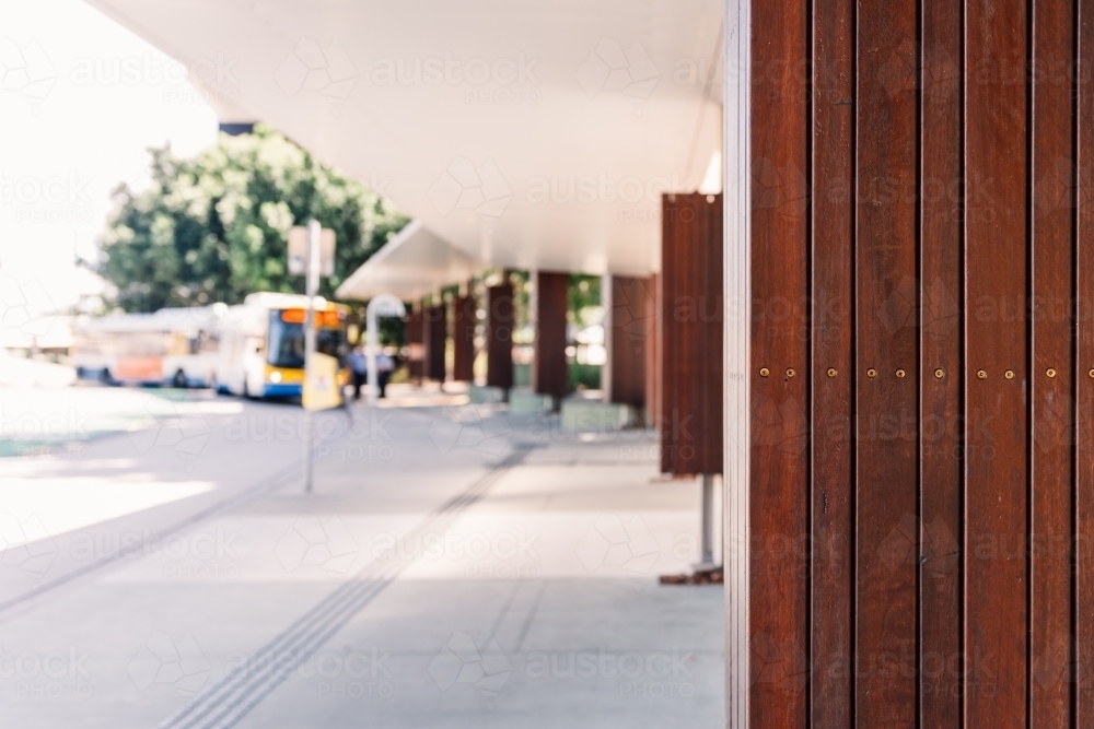 Image of Bus stop with blurred passengers and bus - Austockphoto