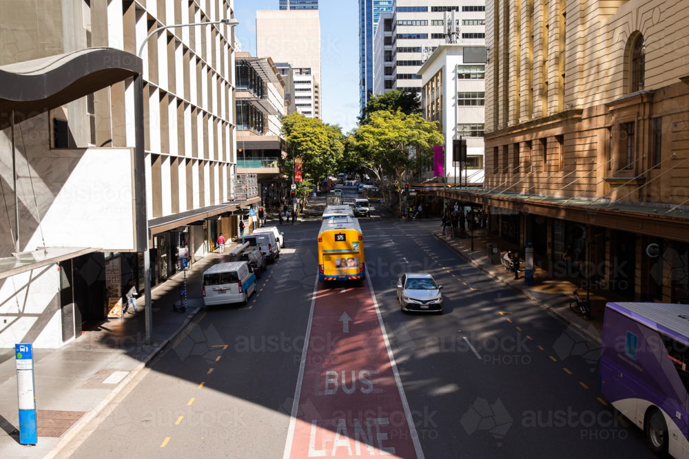 Image of Bus using the bus lane on road in Brisbane city on a sunny day ...